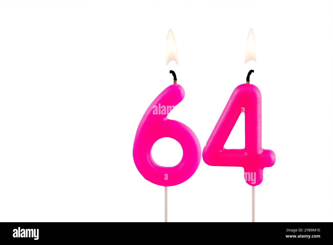Pink number 64 birthday candle lit on white background Stock Photo - Alamy