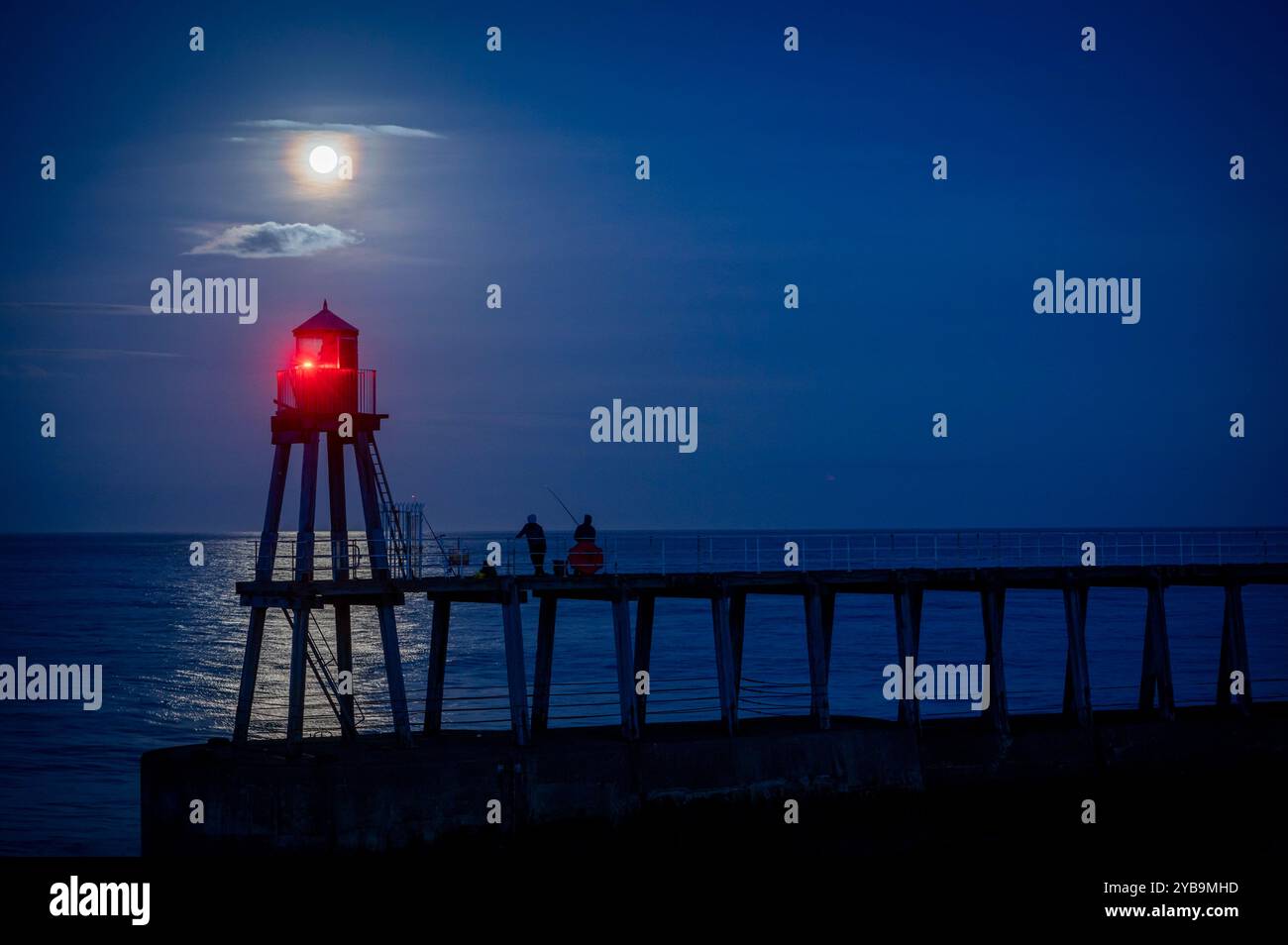 Whitby, UK. 17th Oct, 2024. The full moon rises over Whitby harbour ...