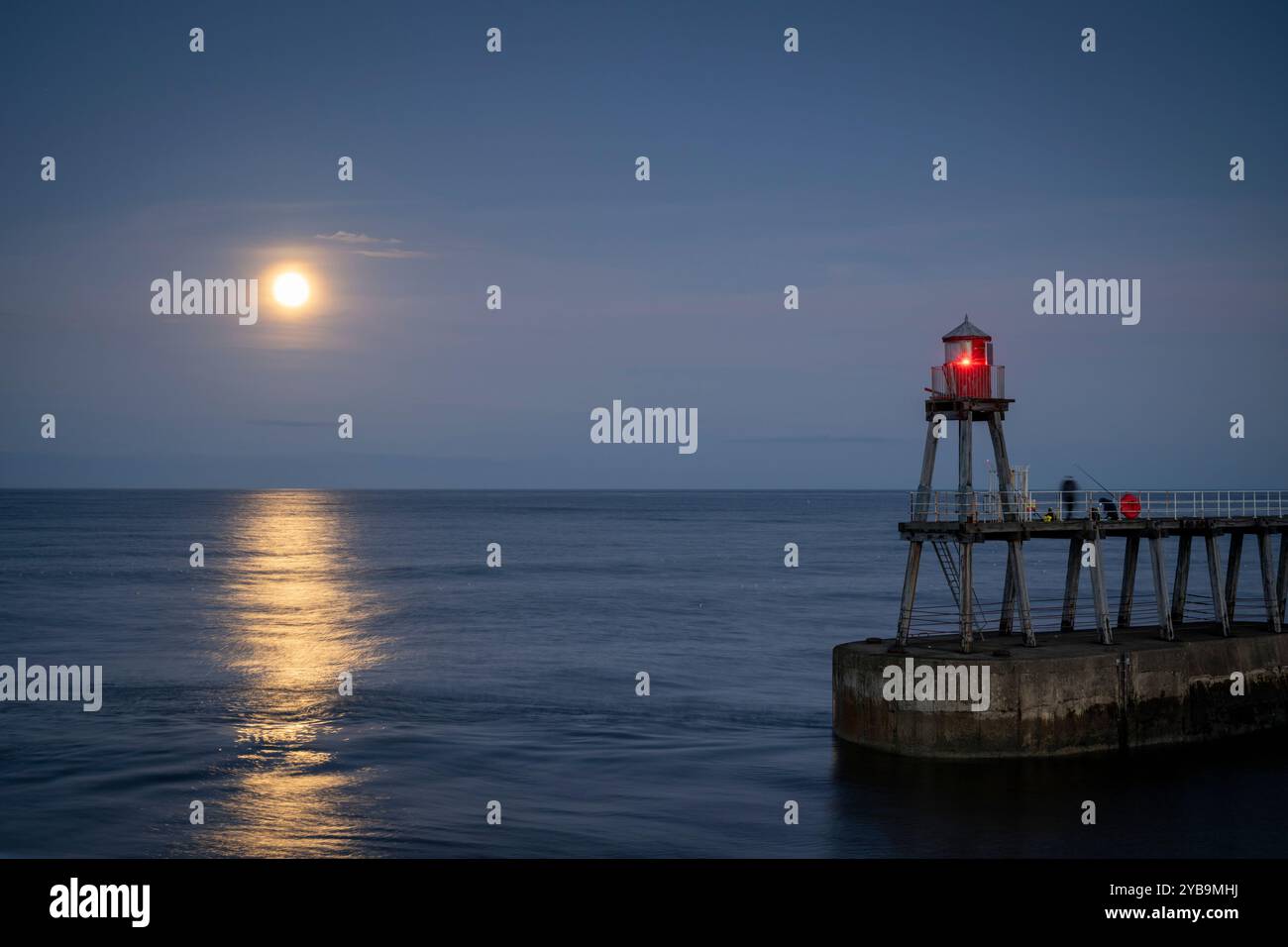 Whitby, UK. 17th Oct, 2024. The full moon rises over Whitby harbour ...