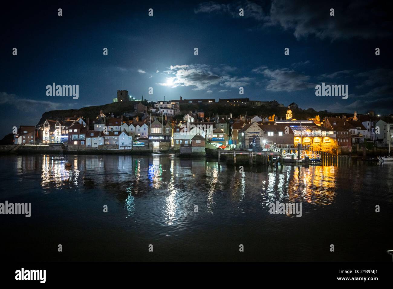 Whitby, UK. 17th Oct, 2024. The full moon rises over Whitby harbour ...