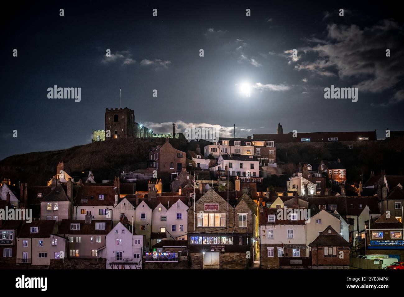 Whitby, UK. 17th Oct, 2024. The full moon rises over Whitby harbour ...