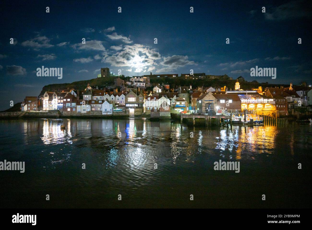 Whitby, UK. 17th Oct, 2024. The full moon rises over Whitby harbour ...