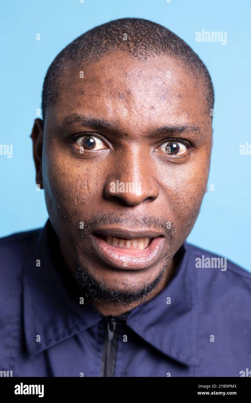 Portrait of security guard acting silly with funny faces on camera ...