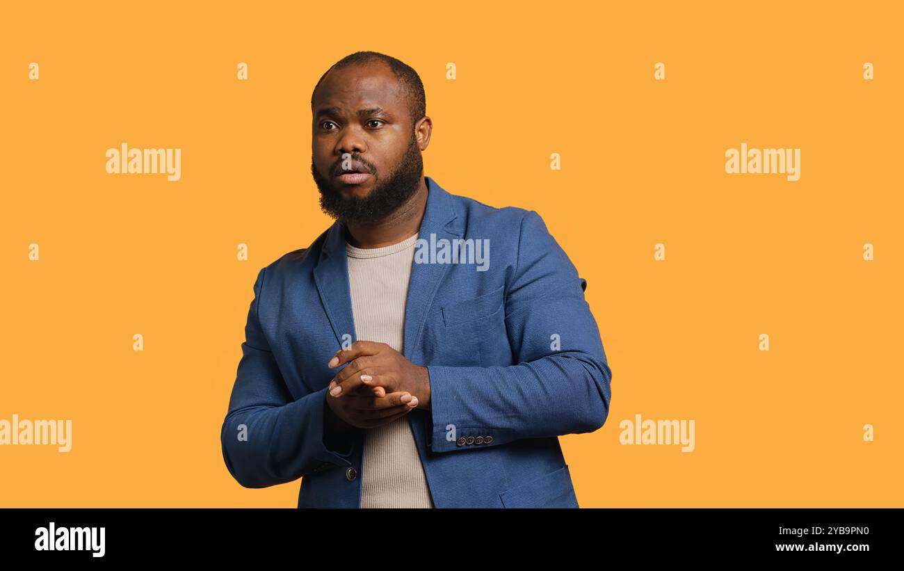 African american man trembling, covering face in shock watching horror ...