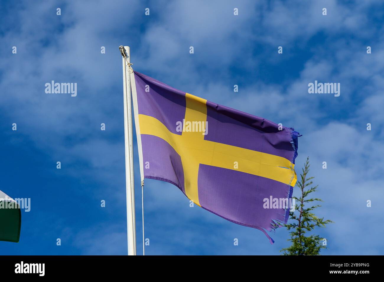 The Swedish flag, featuring blue and yellow colors, flutters gracefully ...