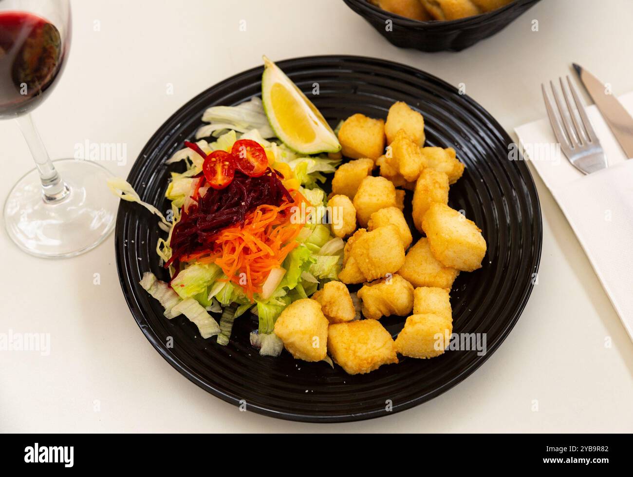 Pieces of fried cuttlefish breaded with vegetables Stock Photo - Alamy