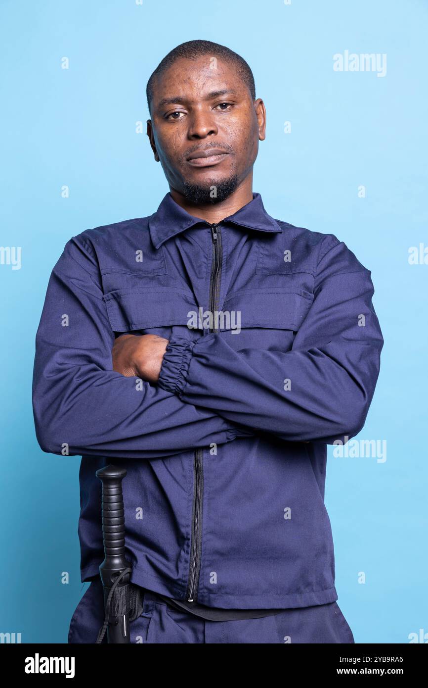 Portrait of african american guard posing with arms crossed against ...