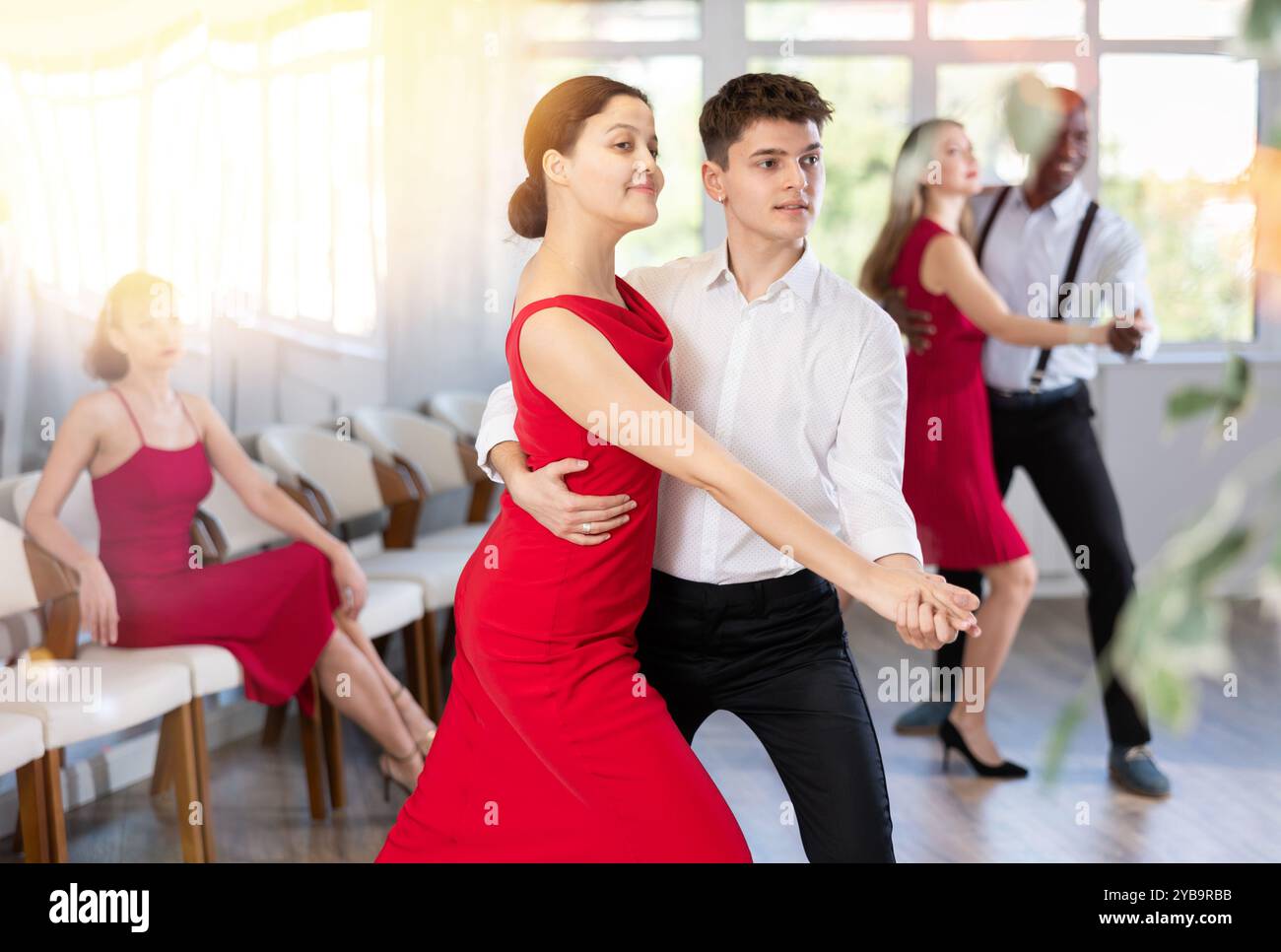 Young guy and young woman dance tango Stock Photo - Alamy