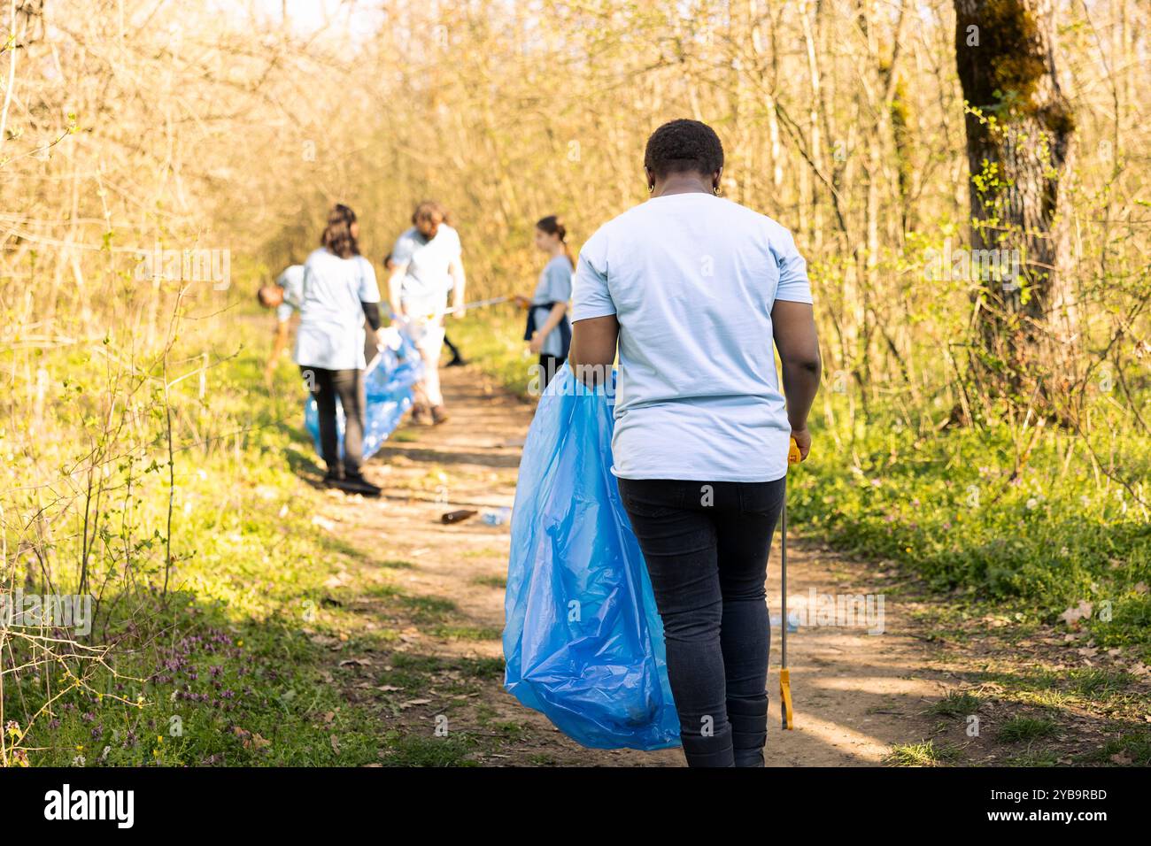 African american activist grabbing trash and plastic bottles from the ...