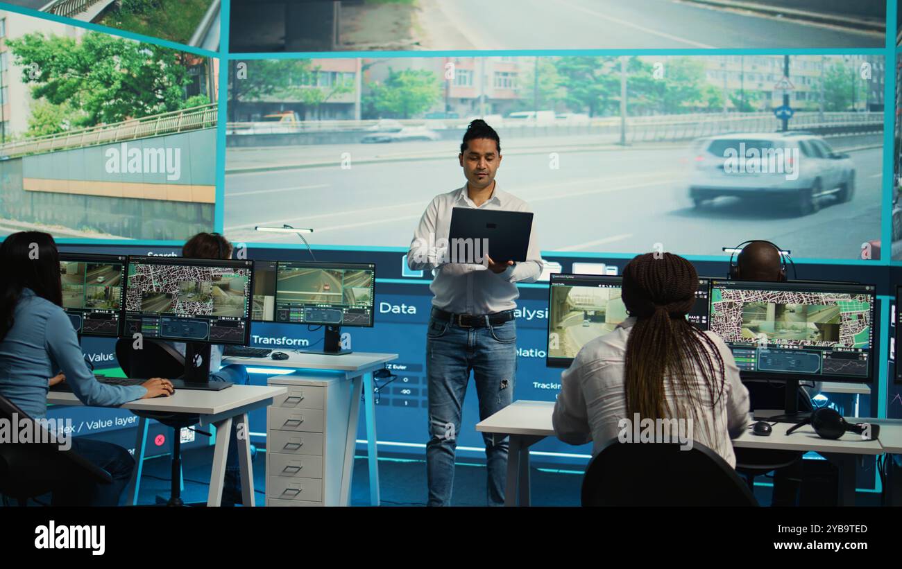 Indian manager supervising his employees team in observation room ...