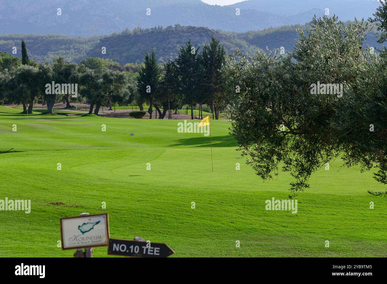 Under the clear sky, the vibrant green golf course invites players to ...