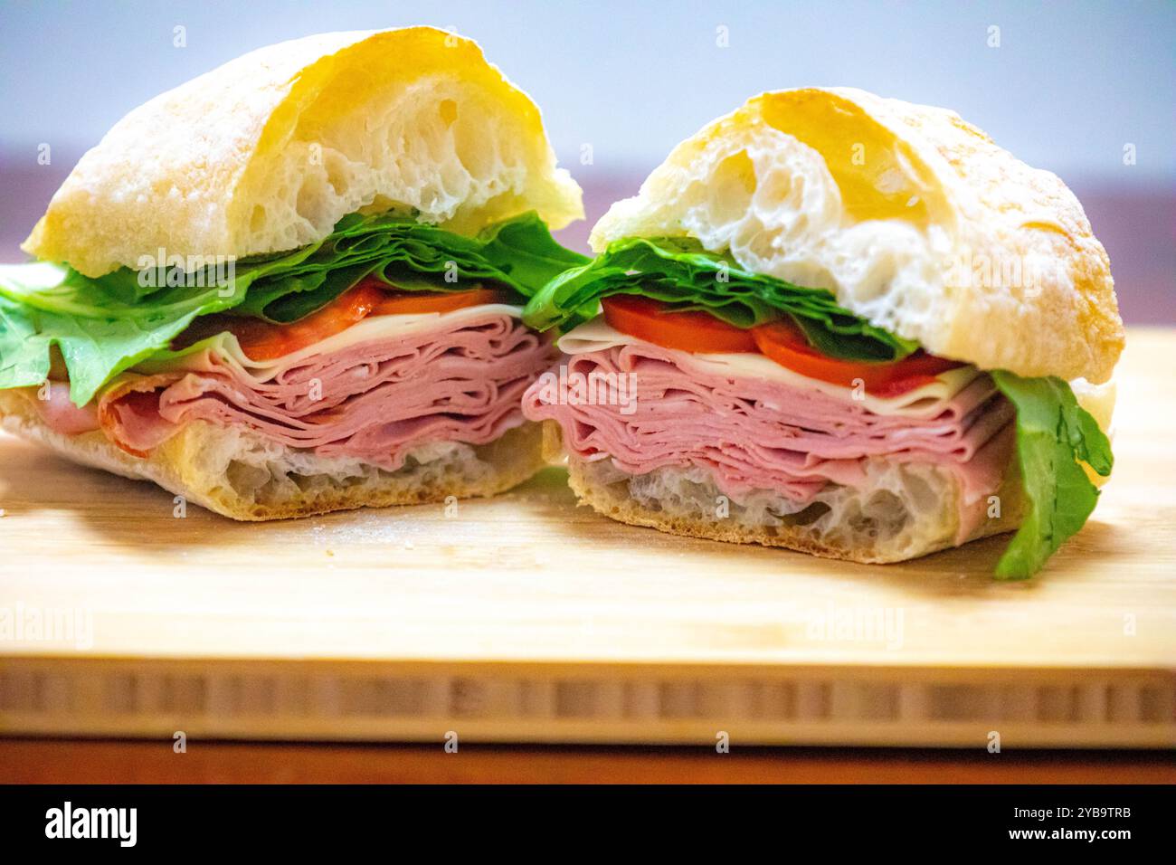 Italian mortadella bologna sandwich with arugula, tomato and cheese on ...