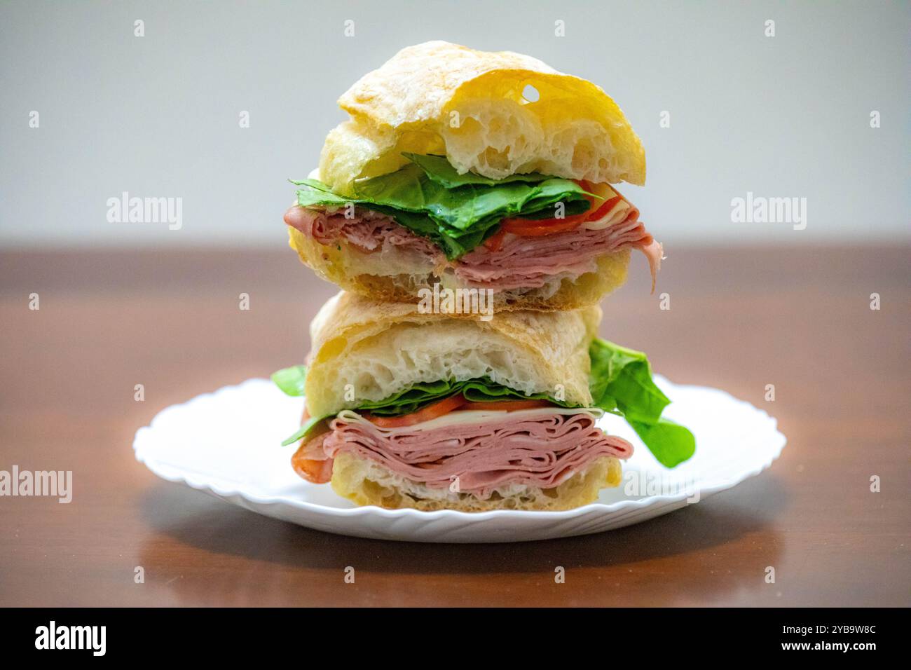 Italian mortadella bologna sandwich with arugula, tomato and cheese on ...