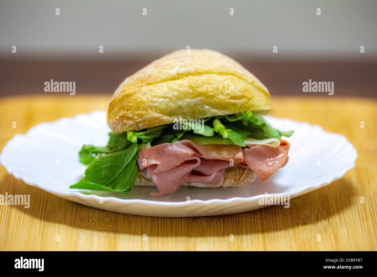 Italian mortadella bologna sandwich with arugula, tomato and cheese on ...