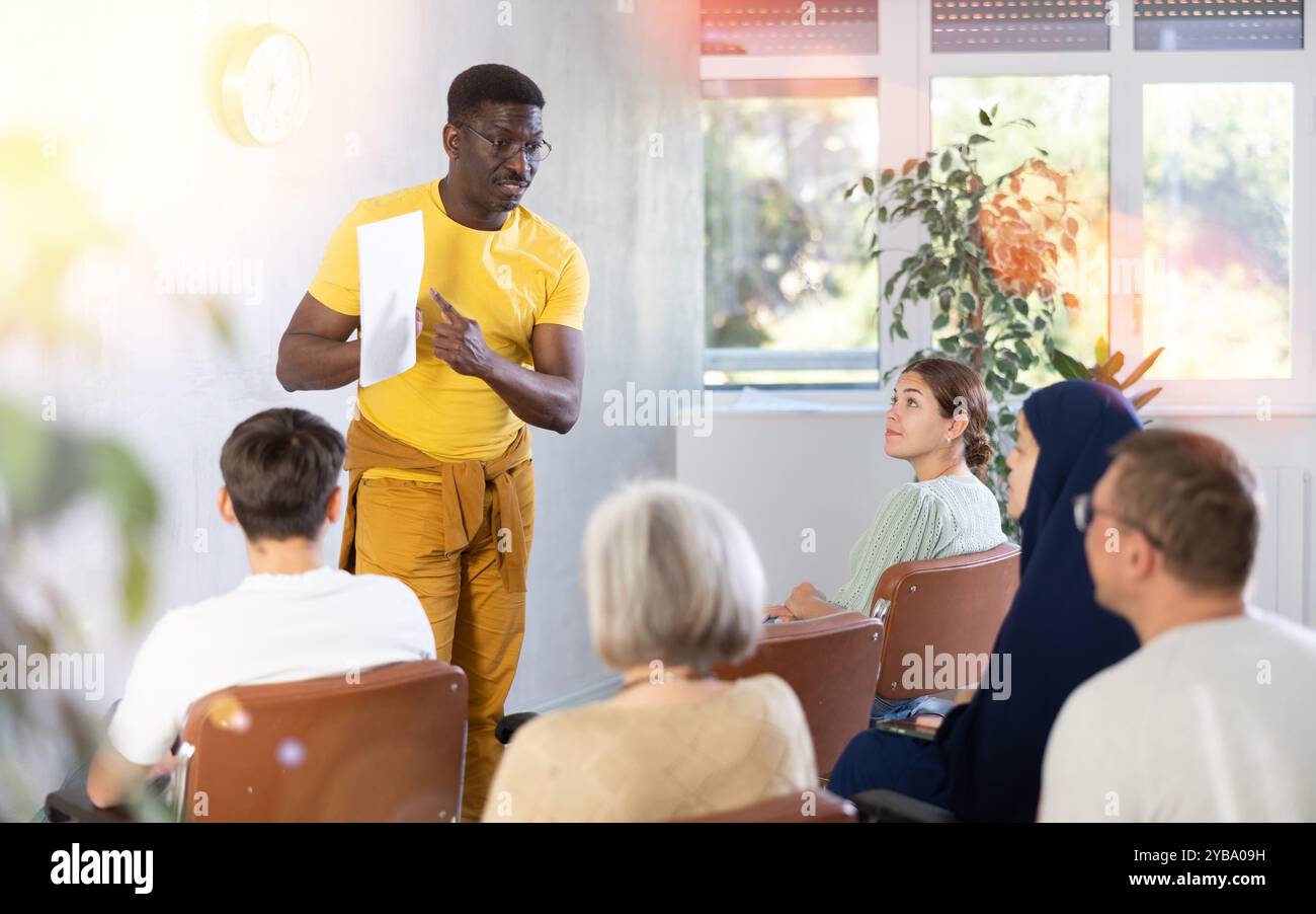 Adult african man giving lecture in office Stock Photo - Alamy