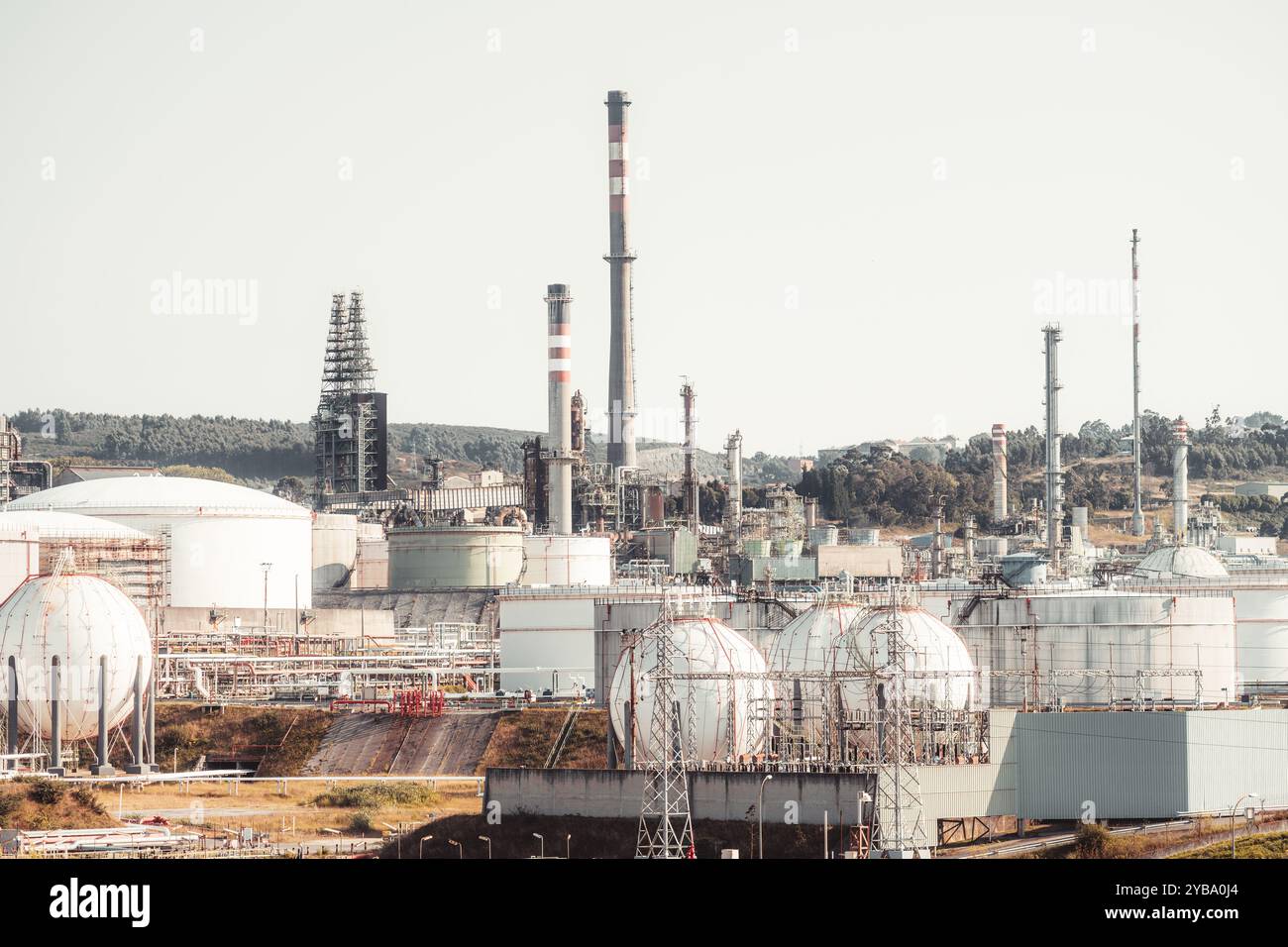 A telephoto shot of a large industrial oil refinery complex with ...