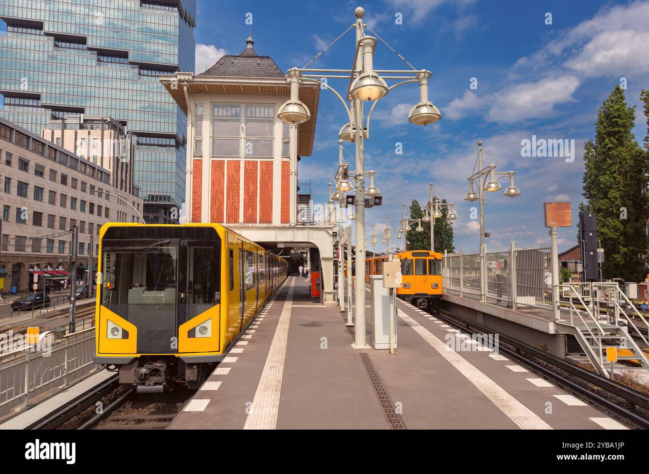 View of a Berlin U-Bahn overground station with yellow metro trains and ...