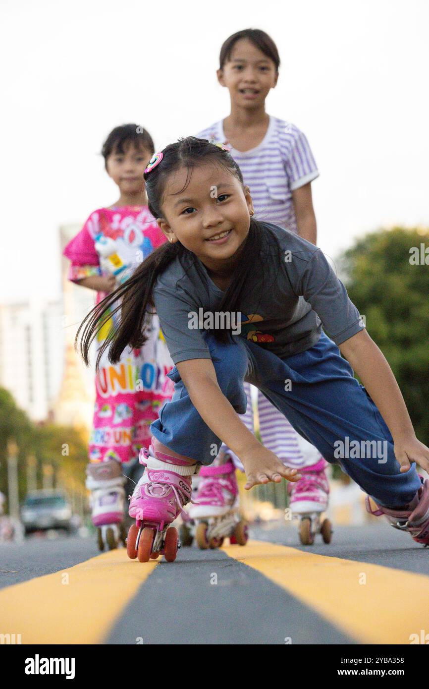 Children roller skating on a street in front of the Royal Palace in the ...