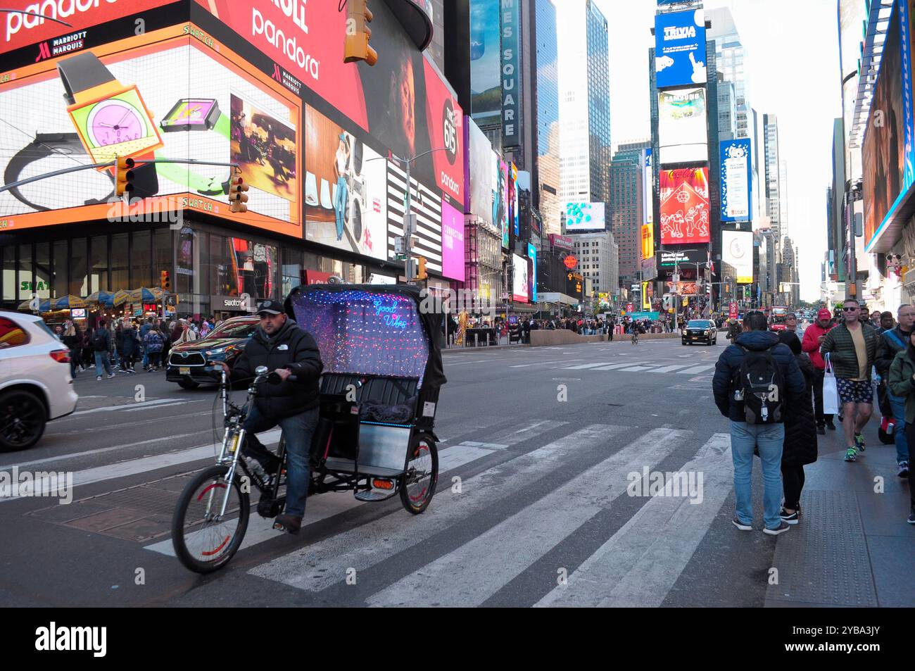 A pedicab driver rides through Times Square, Manhattan, New York City ...