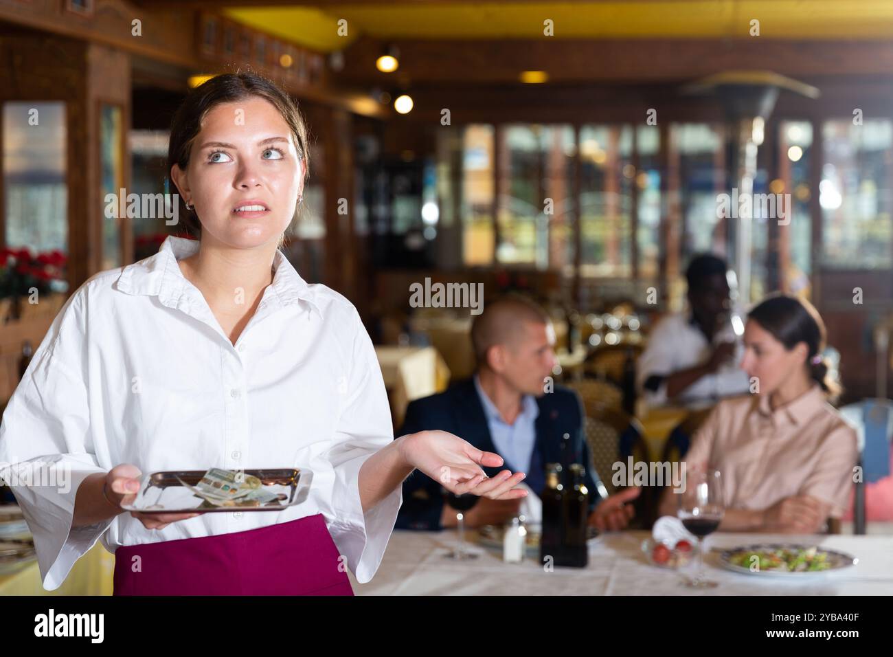 Waitress disappointed in small tip from guests Stock Photo - Alamy