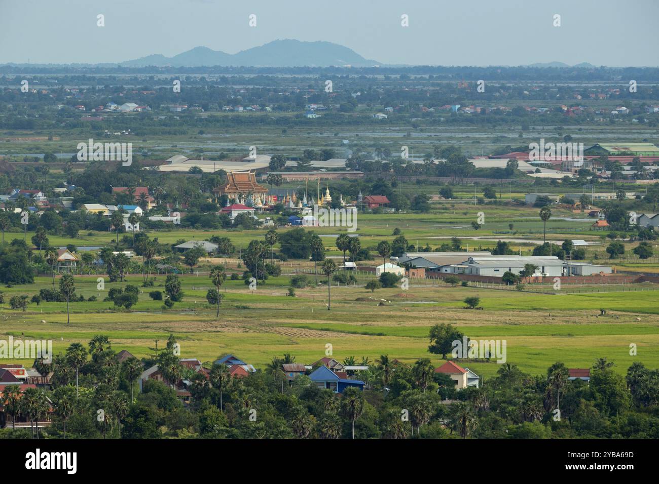 A serene aerial view of the historic Oudong area, nestled amidst lush ...