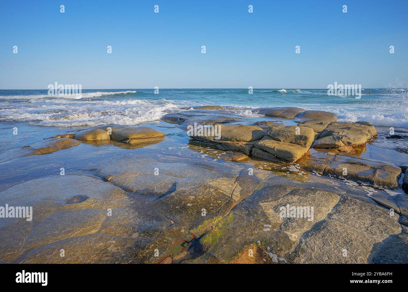 Surf waves breaking over the rocky headland at Point Cartwright at ...
