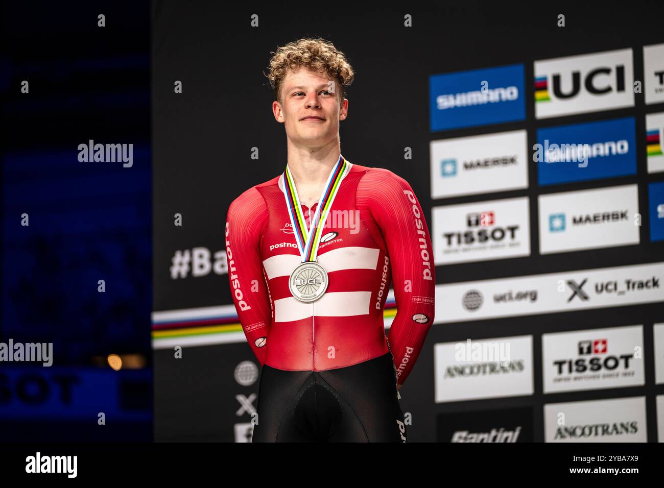 Denmark's Tobias Aagaard Hansen stands with his medal on the podium ...