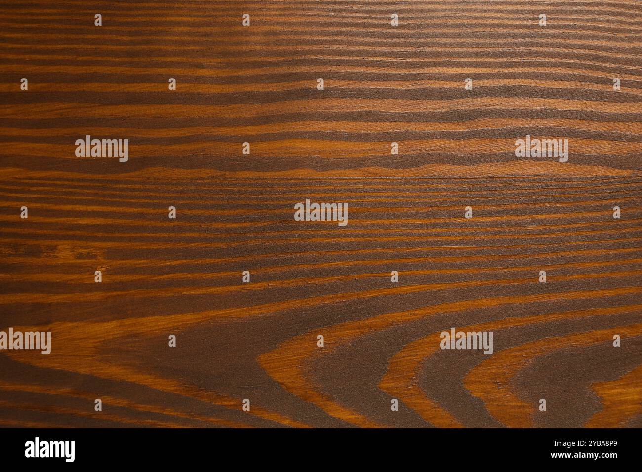 Applying walnut wood stain. Texture of wooden surface as background ...
