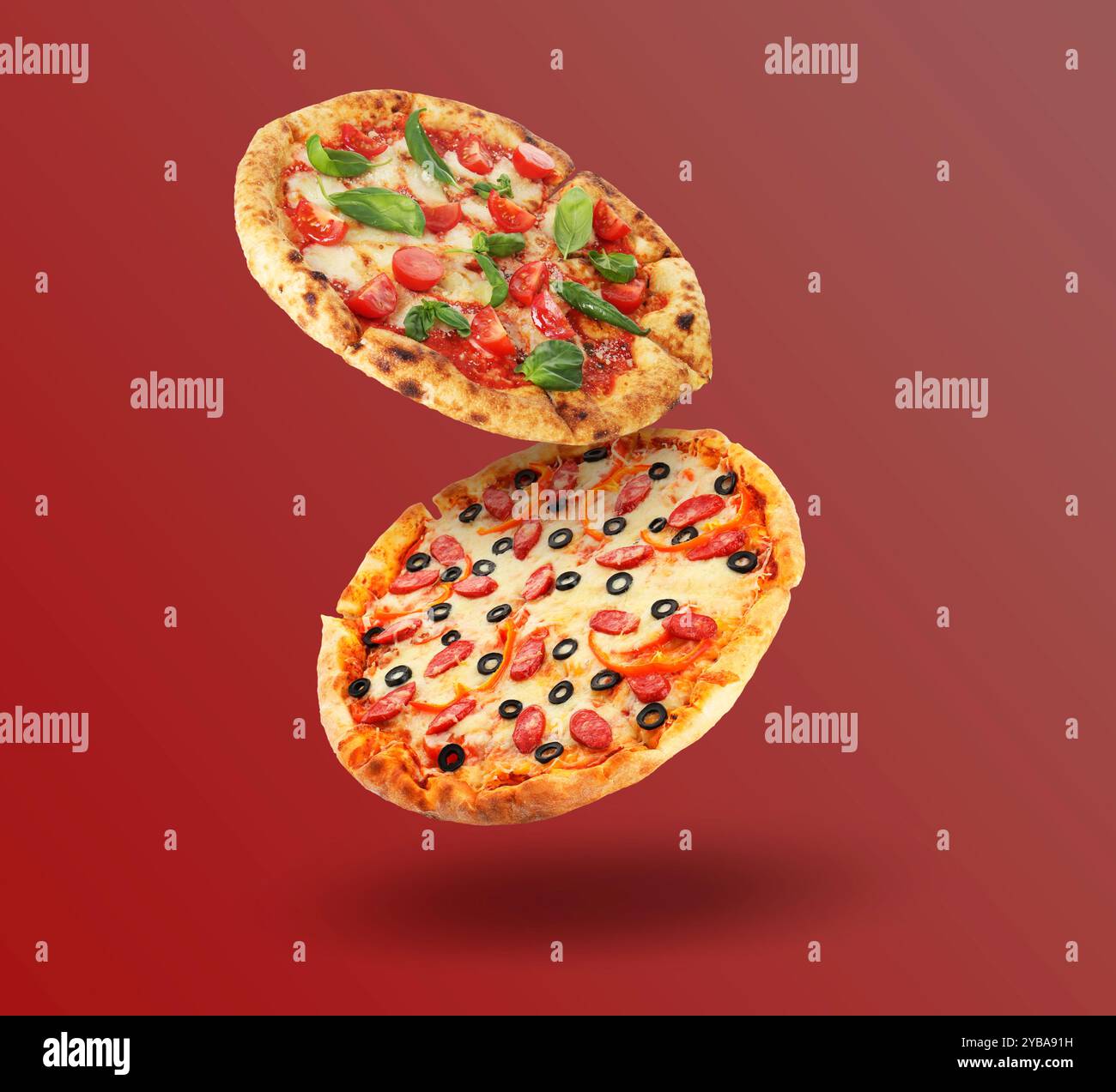 Different pizzas in air on red gradient background Stock Photo - Alamy