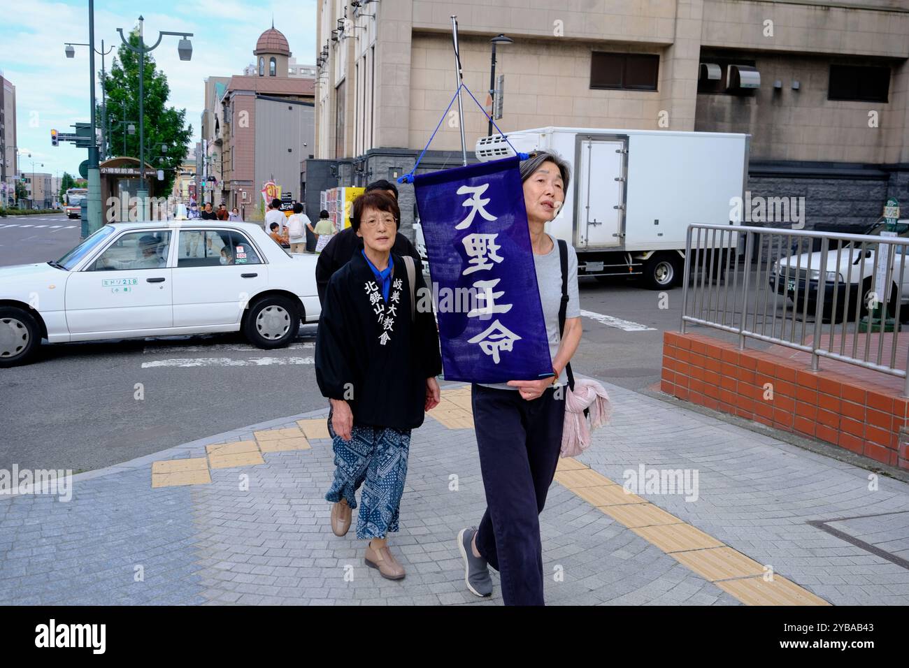 A group of Christian church members with a religious banner walking on ...