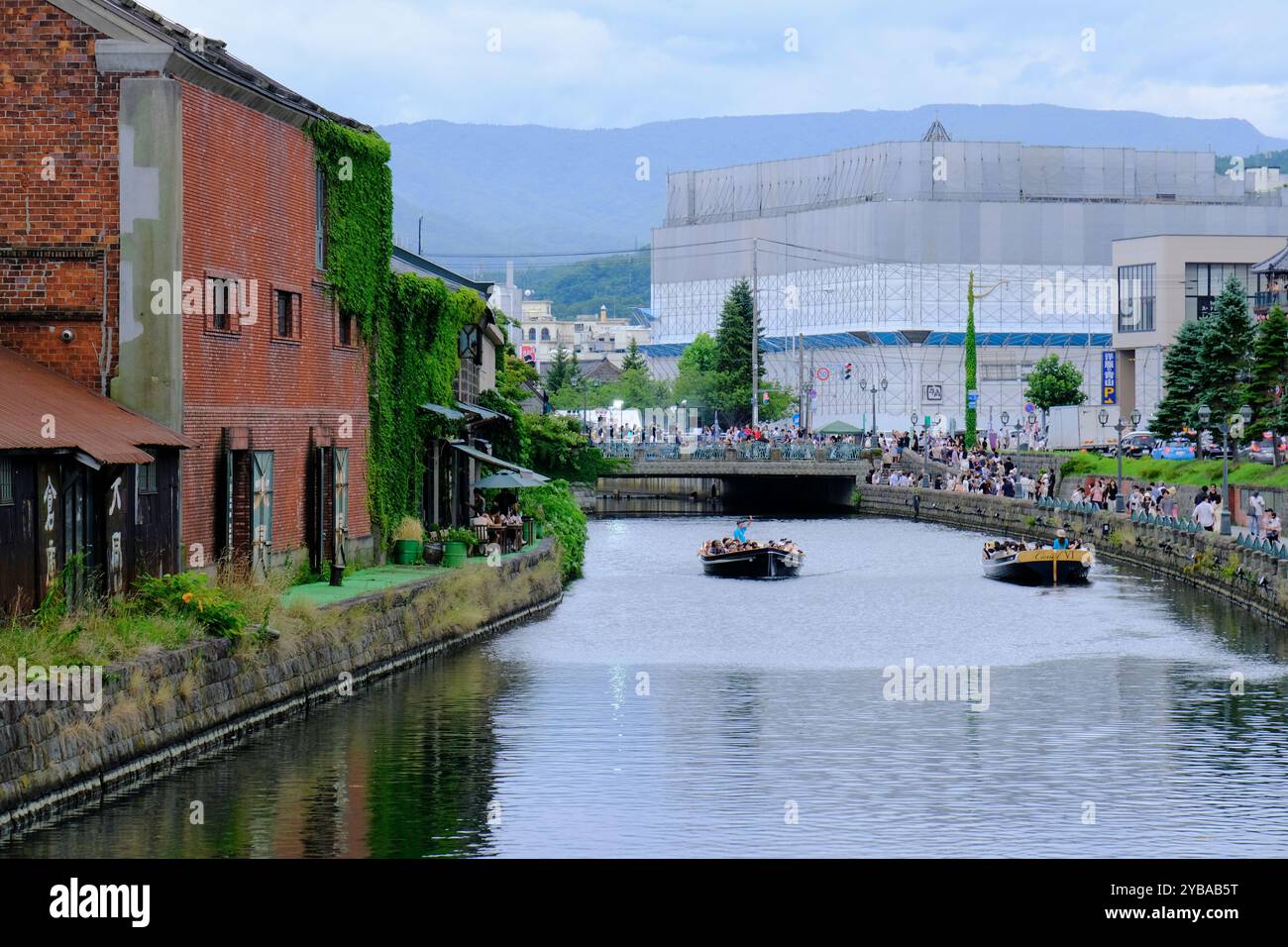 Tour boats in Otaru Canal with historic warehouses beside.Otaru ...