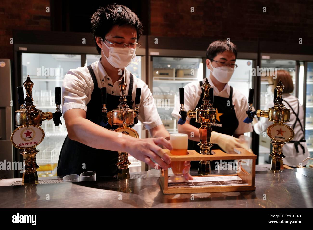 Workers serving beer for visitors in Star Hall the paid testing hall in ...