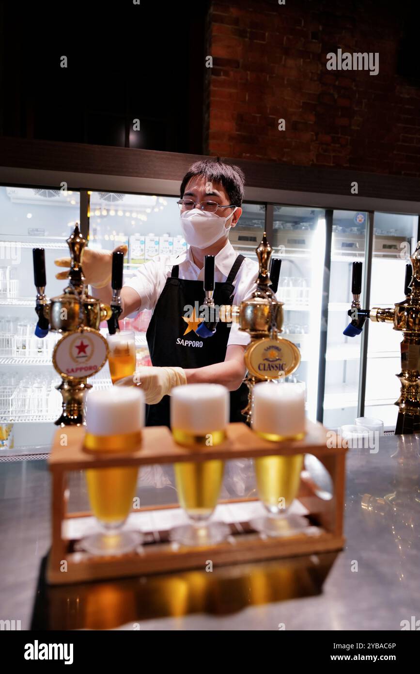 Workers pouring beer for visitors in Star Hall the paid testing hall in ...
