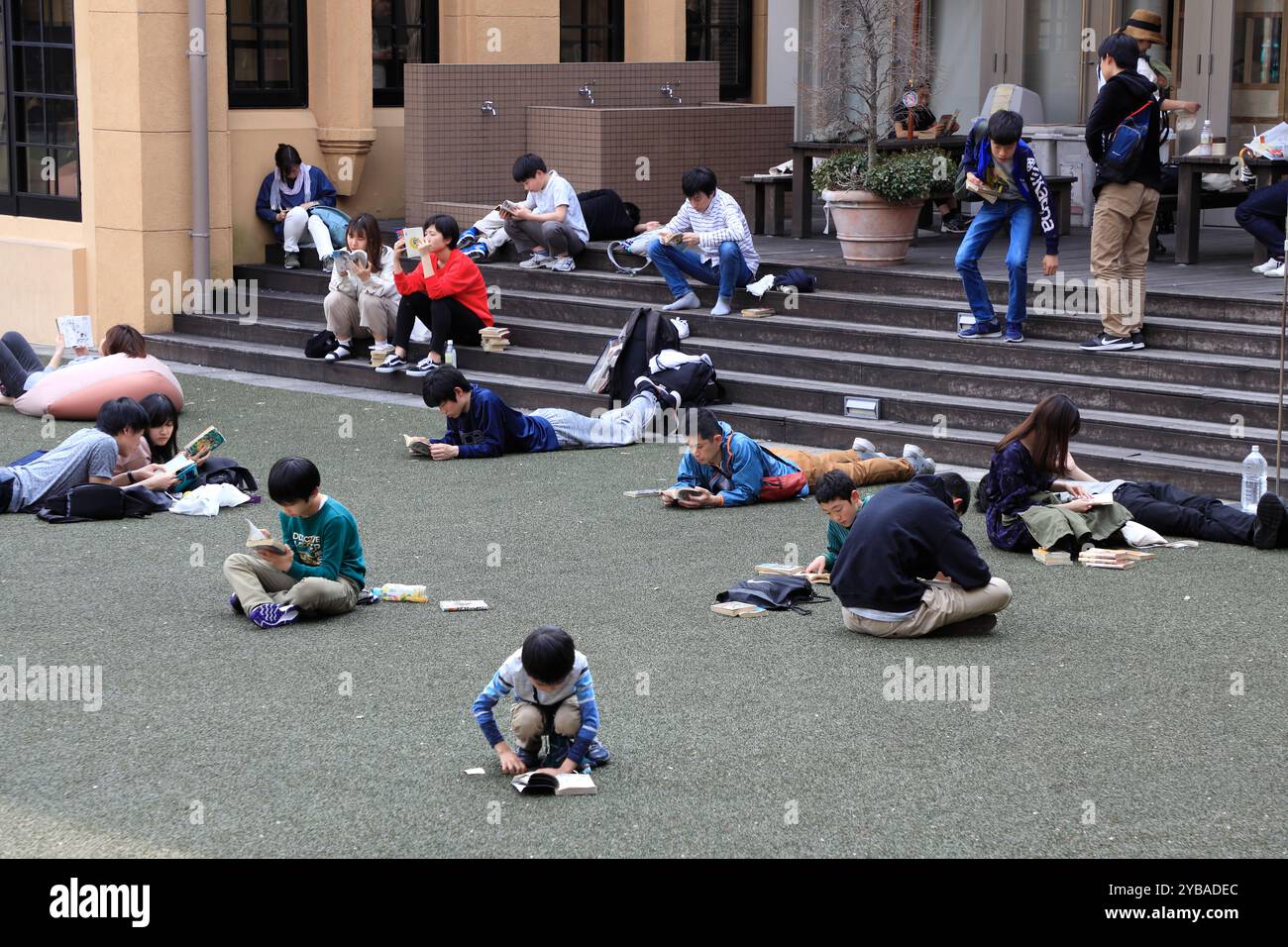 Visitors reading mangas in the courtyard of Kyoto International Manga ...