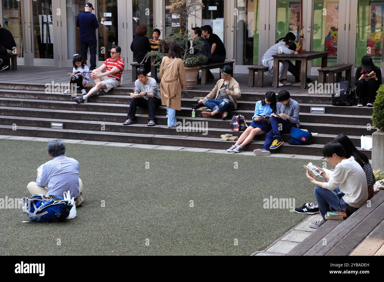 Visitors reading mangas in the courtyard of Kyoto International Manga ...