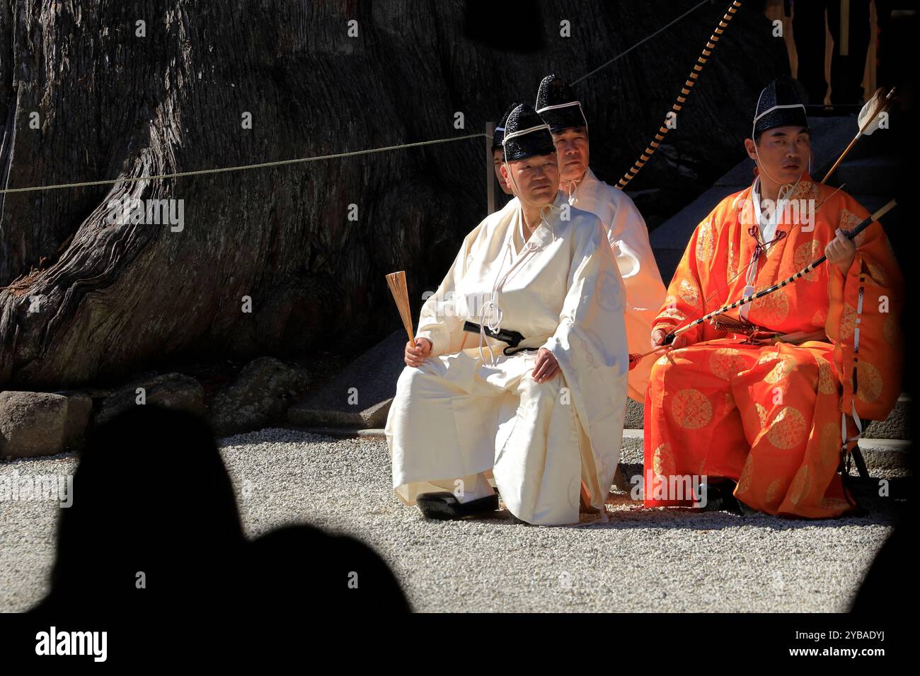 Male archers in traditional ceremonial robe and head piece in the ...