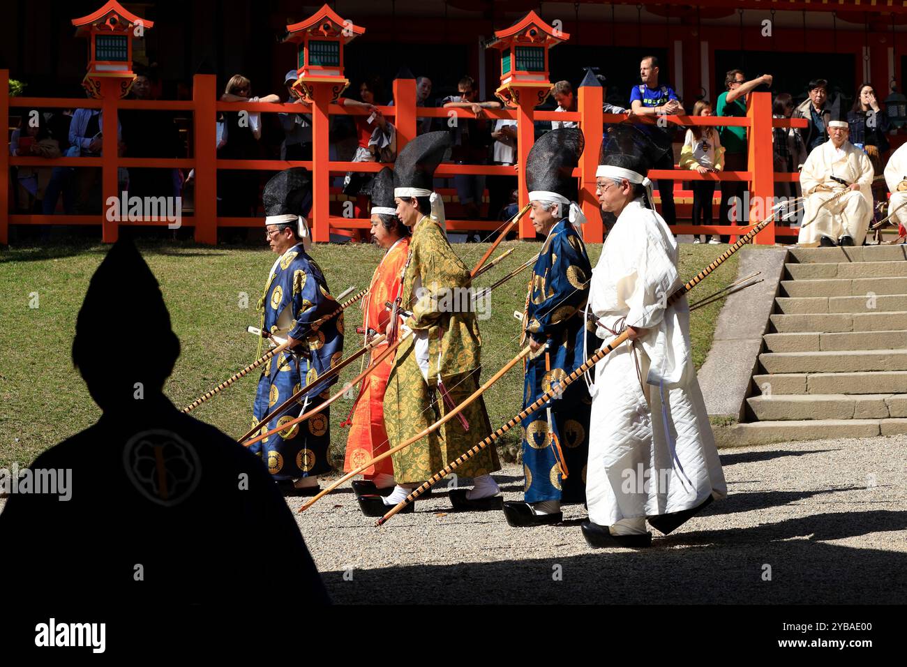 Male archers in traditional ceremonial robe and head piece in the ...