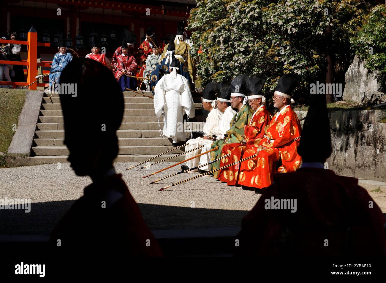 Male archers in traditional ceremonial robe and head piece in the ...