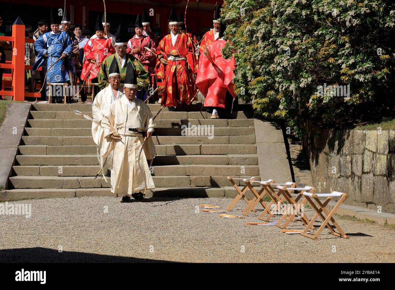 Male archers in traditional ceremonial robe and head piece entering the ...