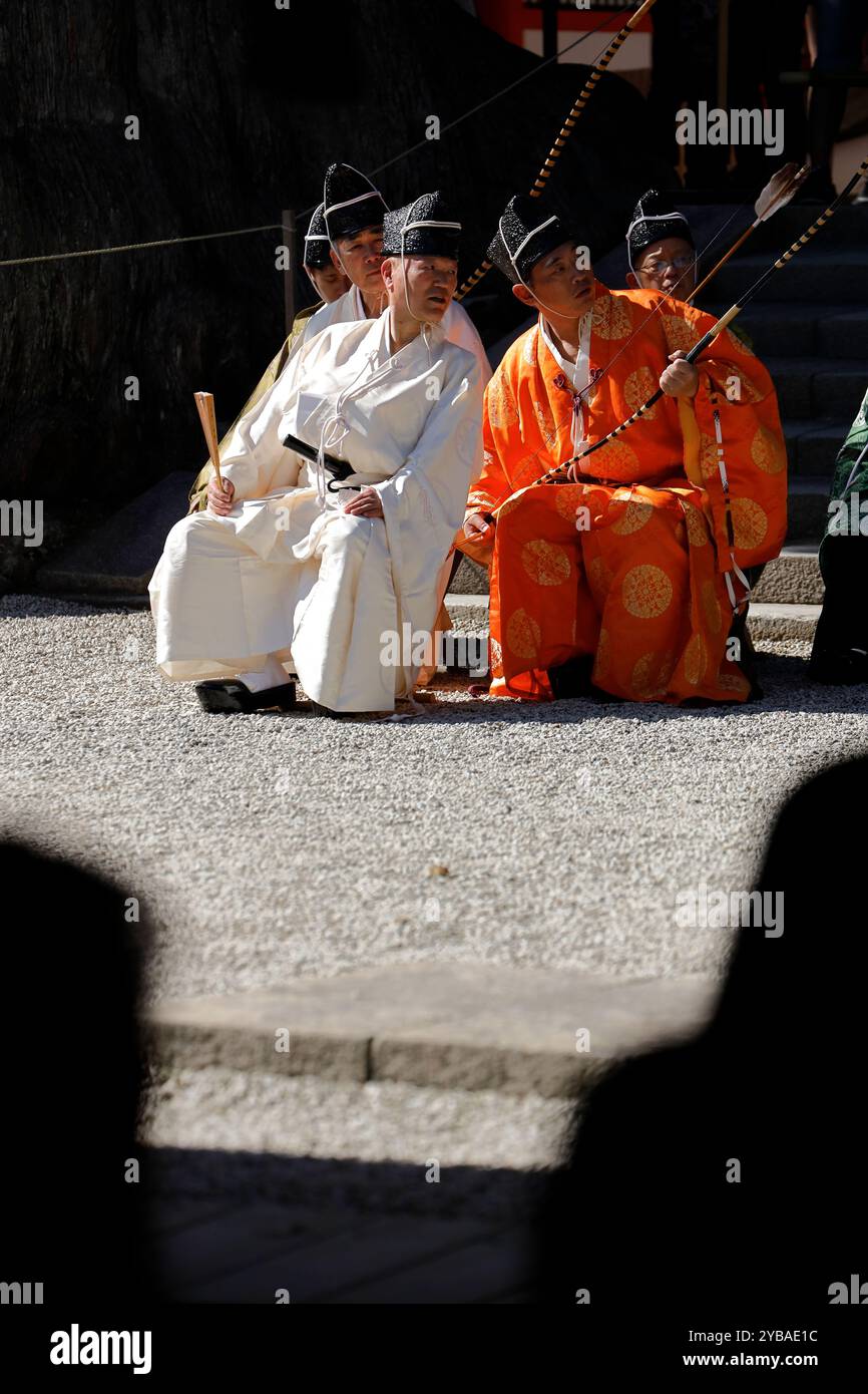 Male archers in traditional ceremonial robe and head piece in the ...