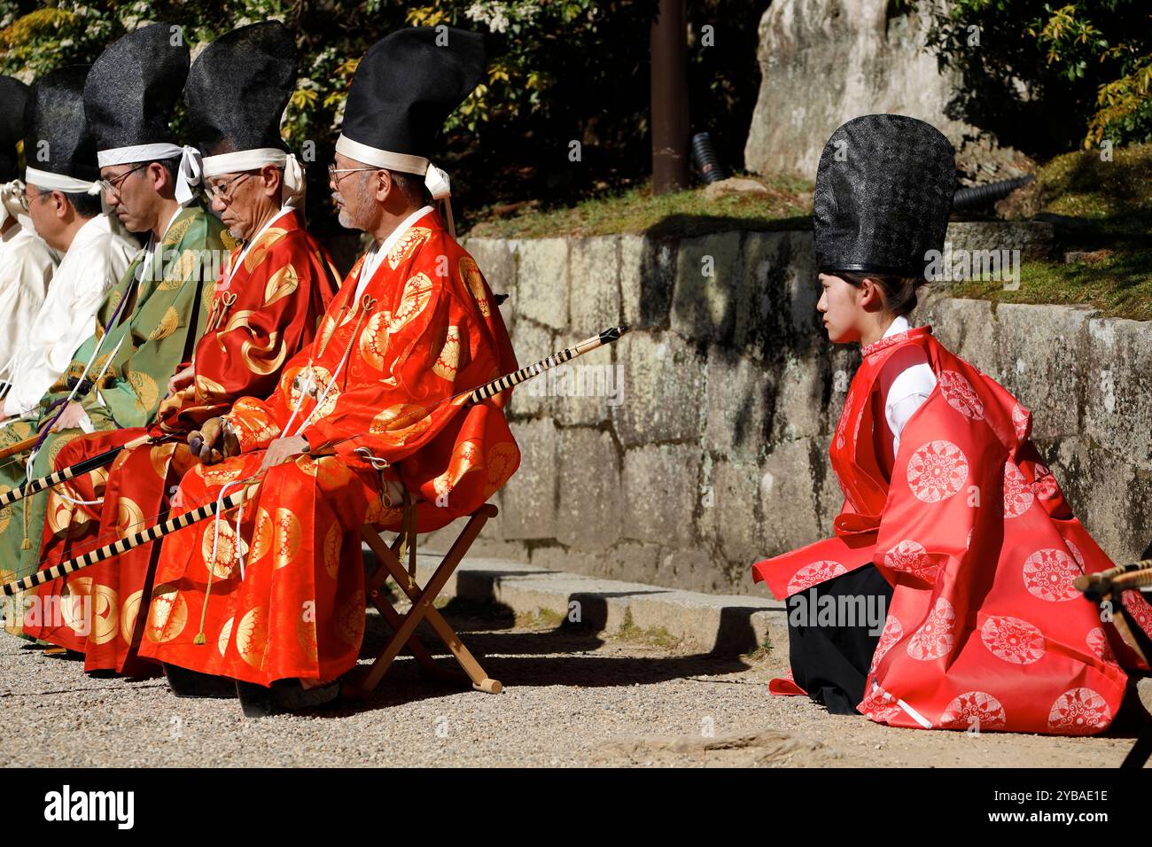 Male archers in traditional ceremonial robe and head piece in the ...