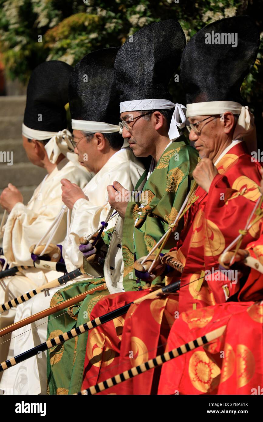 Male archers in traditional ceremonial robe and head piece in the ...