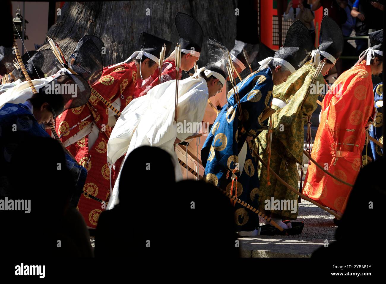 Male archers in traditional ceremonial robe and head piece in the ...