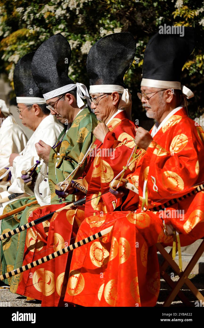 Male archers in traditional ceremonial robe and head piece in the ...