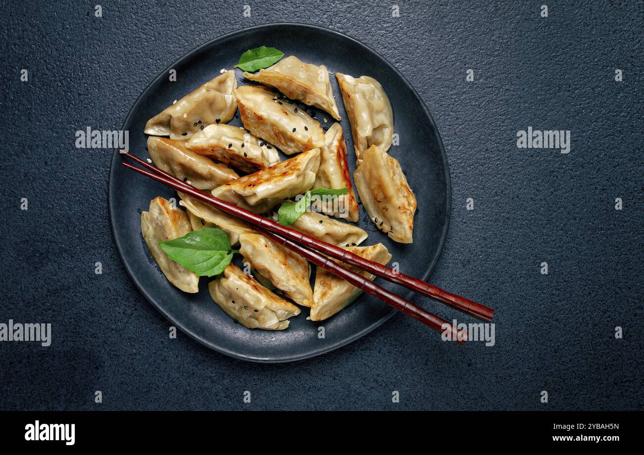 Japanese fried gyoza dumplings, with pork, sesame seeds, green onions ...