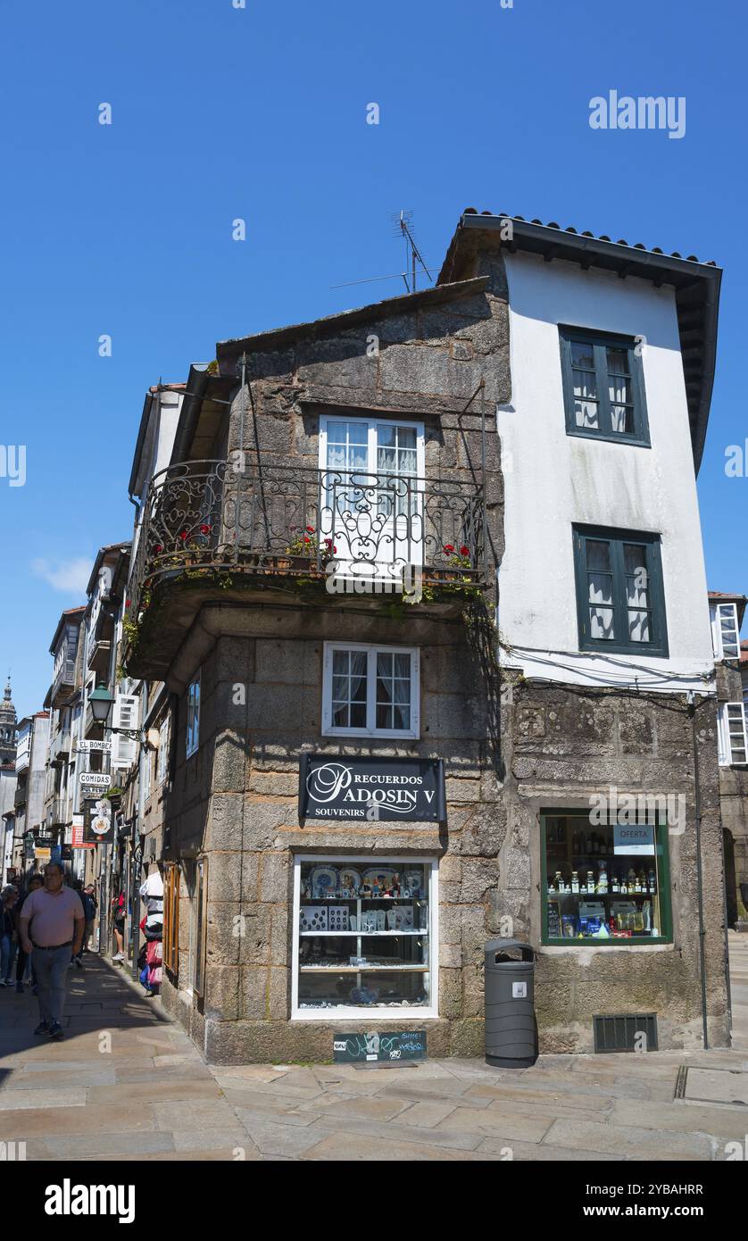 Rustic old stone house with balconies and a shop in an urban ...