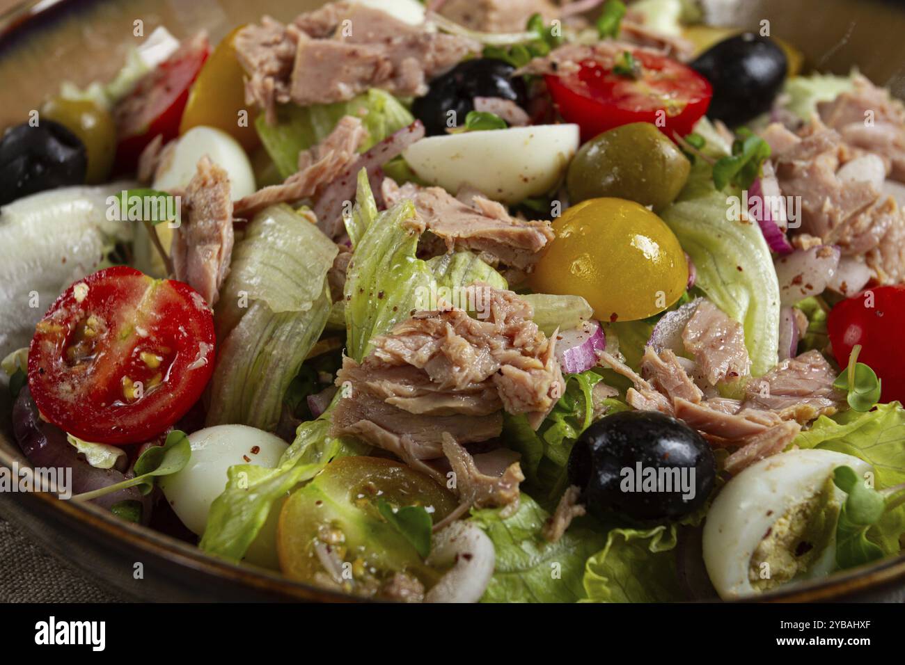Salad with canned tuna, vegetable salad with quail eggs, lettuce, red ...