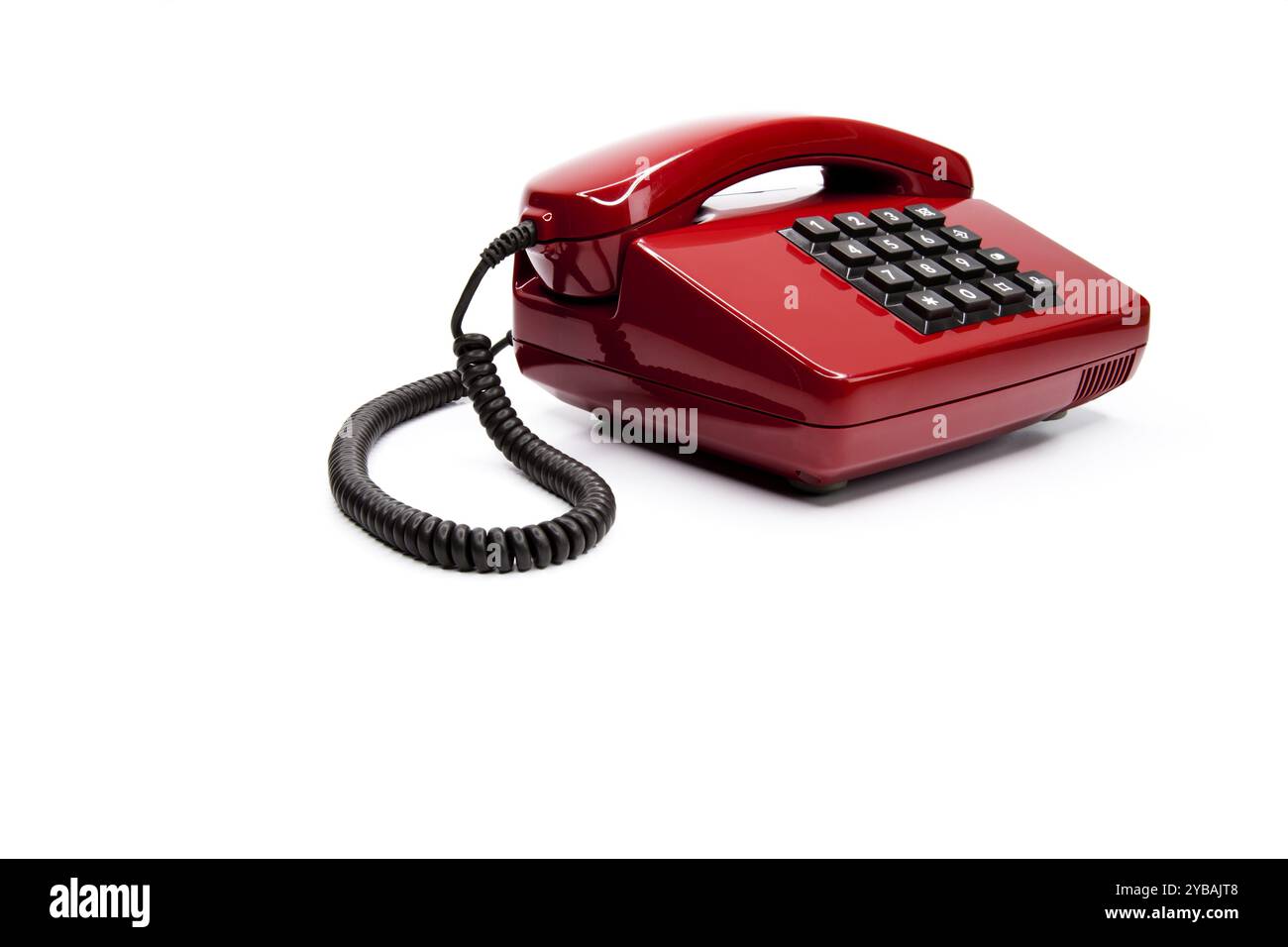 Classic red telephone from the eighties, against a white background ...