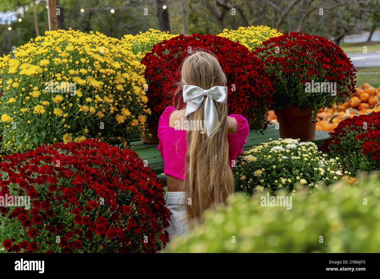A beautiful European blonde female pics out some flowers for the ...