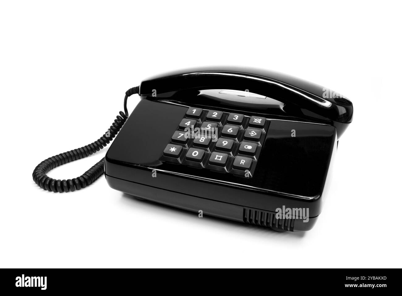 Classic black telephone from the eighties, against a white background ...